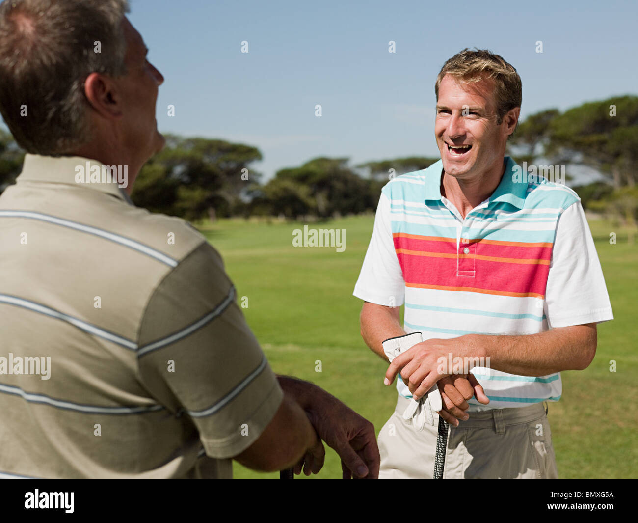 Two mature men playing golf together Stock Photo - Alamy