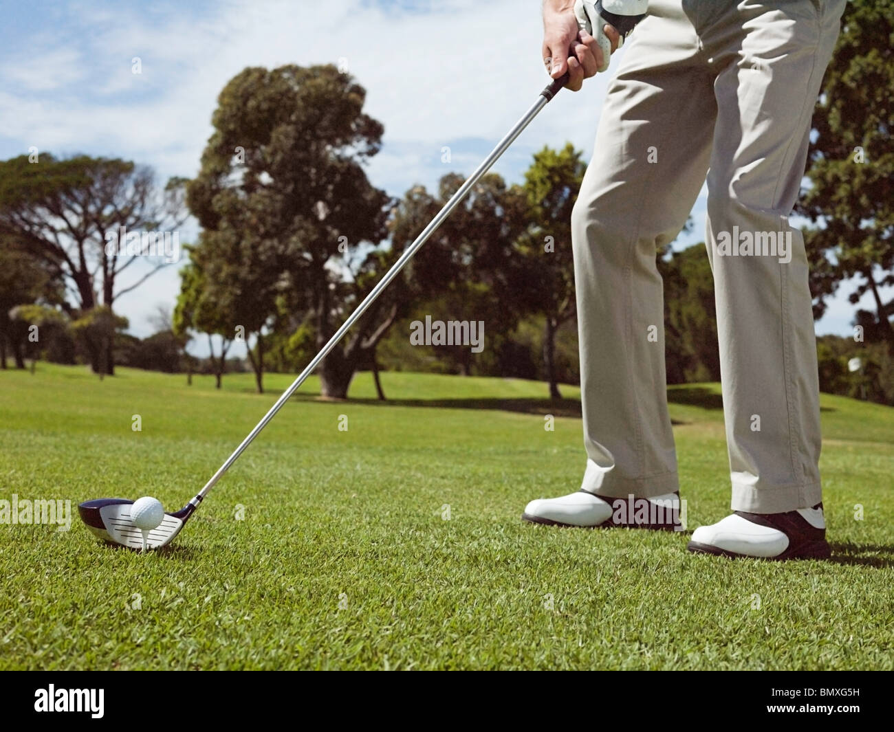 Man playing golf on golf course Stock Photo - Alamy