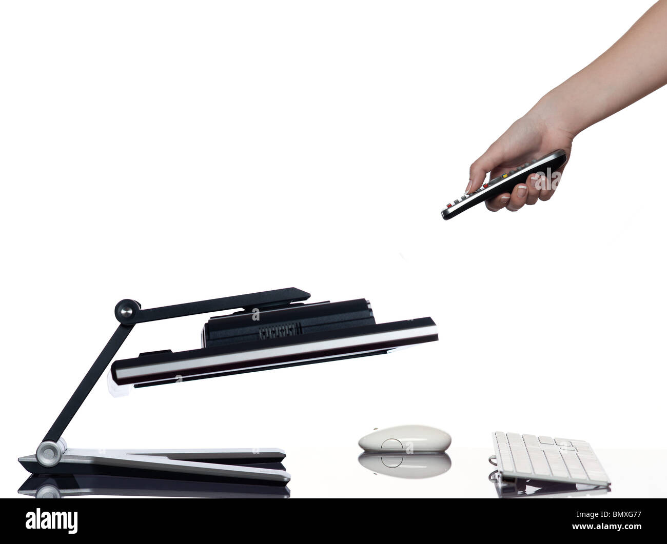 human hand holding remote control and a computer display monitor on ...