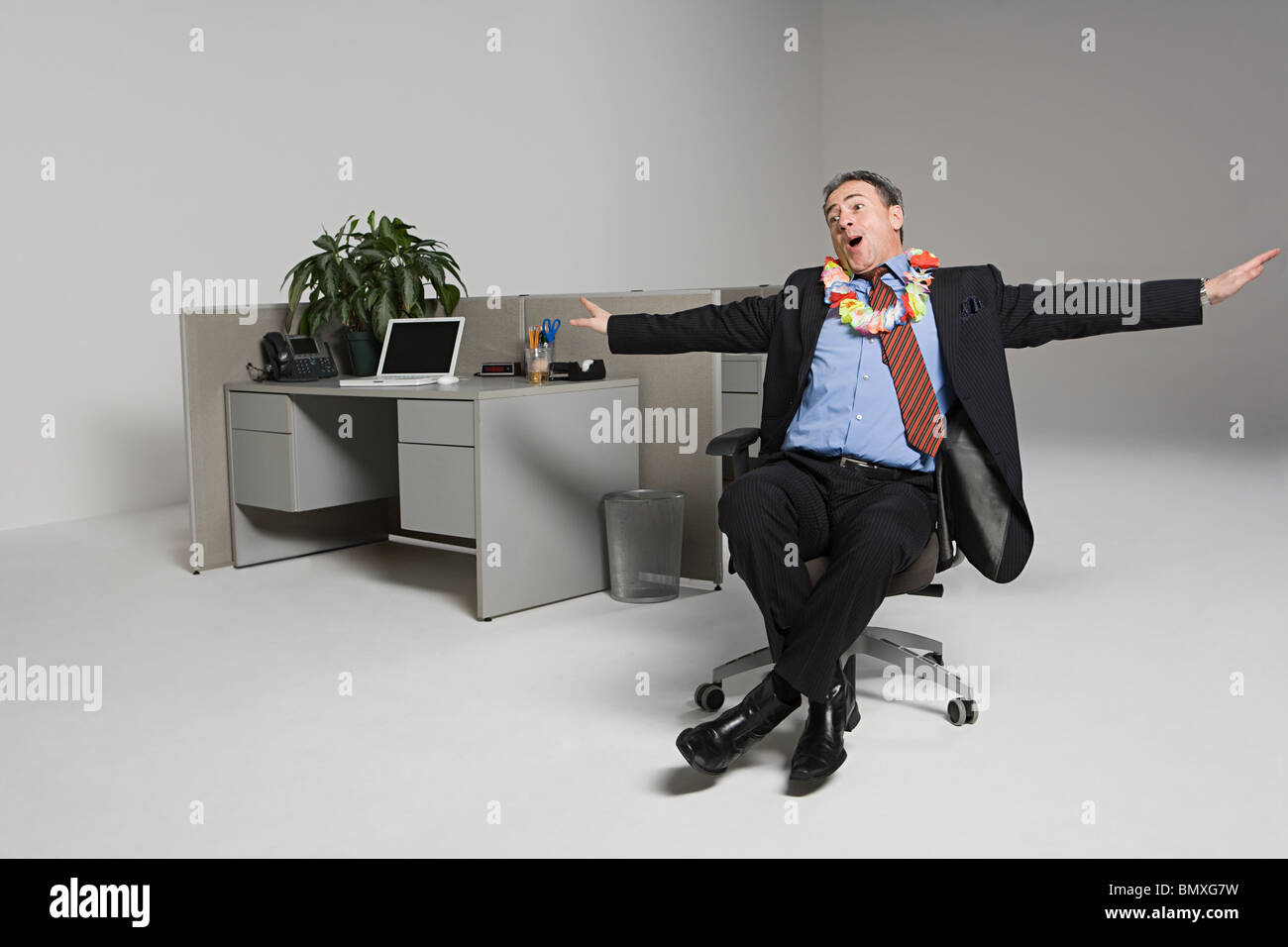 Businessman messing around on office chair Stock Photo - Alamy