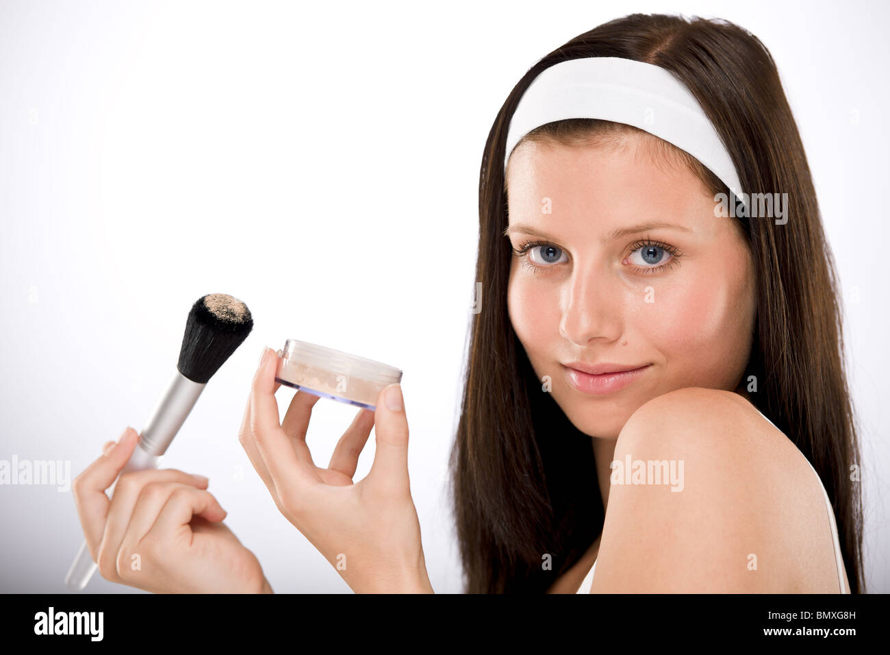 Beautiful woman applying powder with brush on white background Stock ...