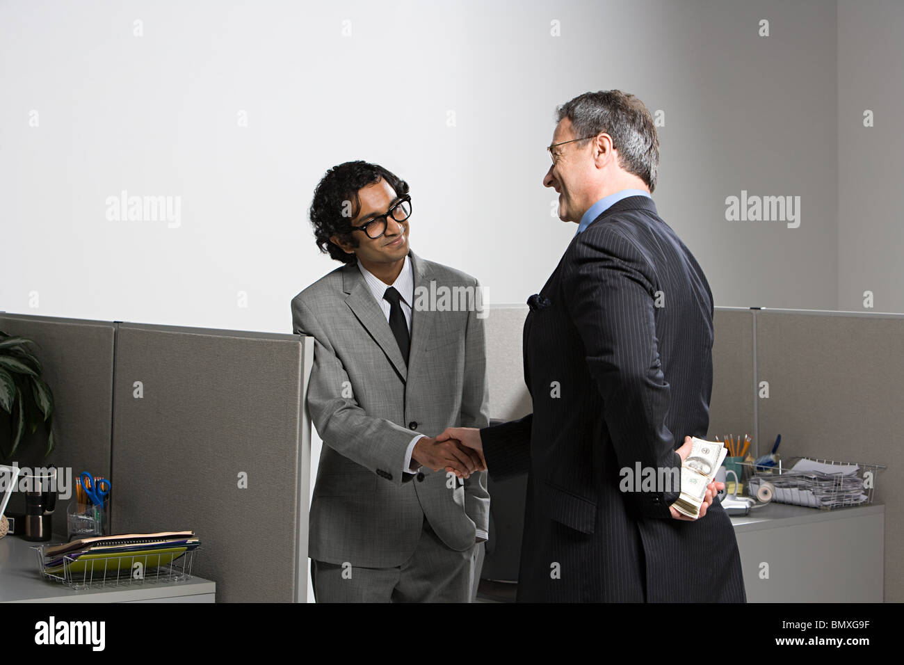 Businessman holding money behind his back Stock Photo - Alamy