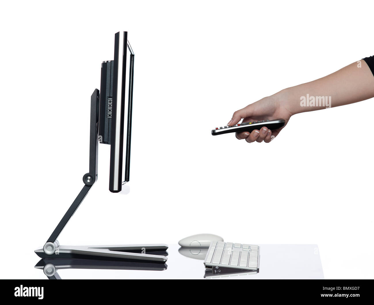human hand pointing remote control and a computer display monitor on ...