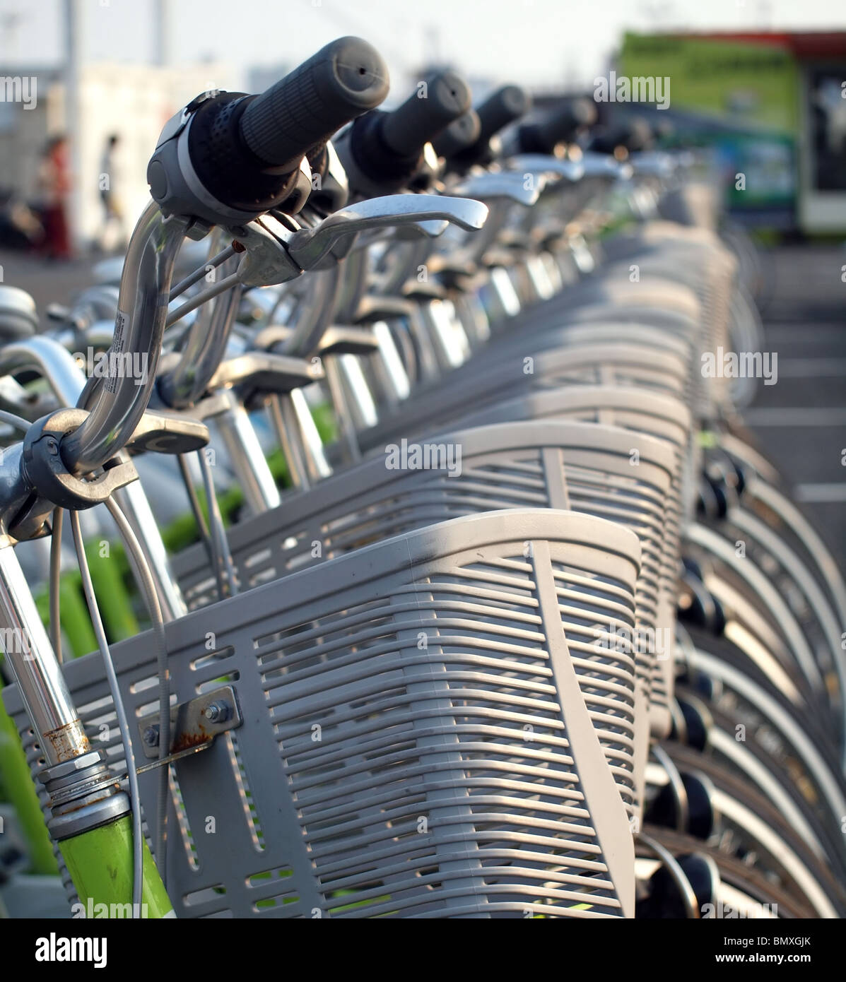A row of green rental bicycles with gray baskets Stock Photo - Alamy