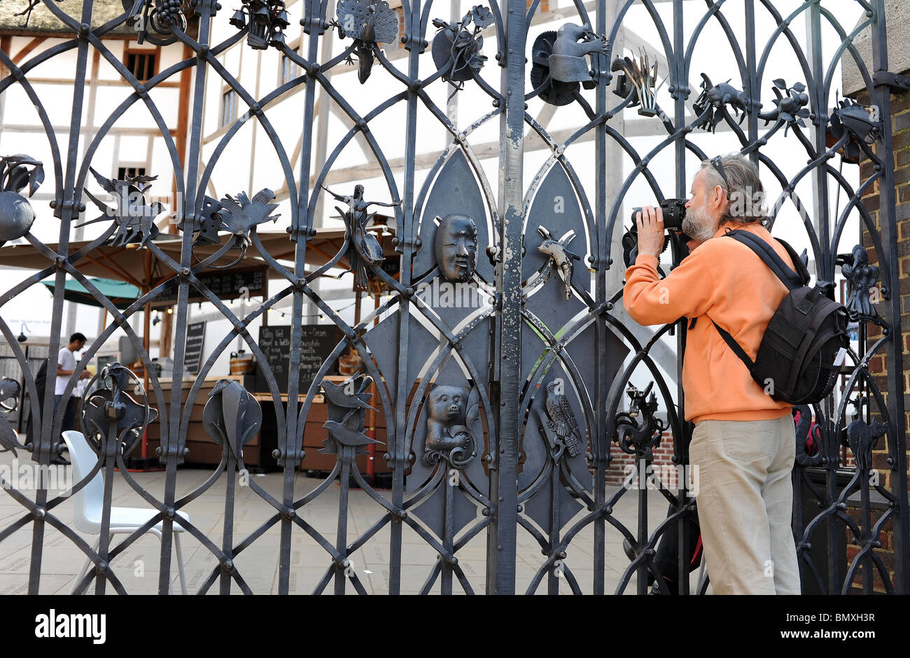 Tourist taking photographs at the beautiful Globe Theater gates. London ...