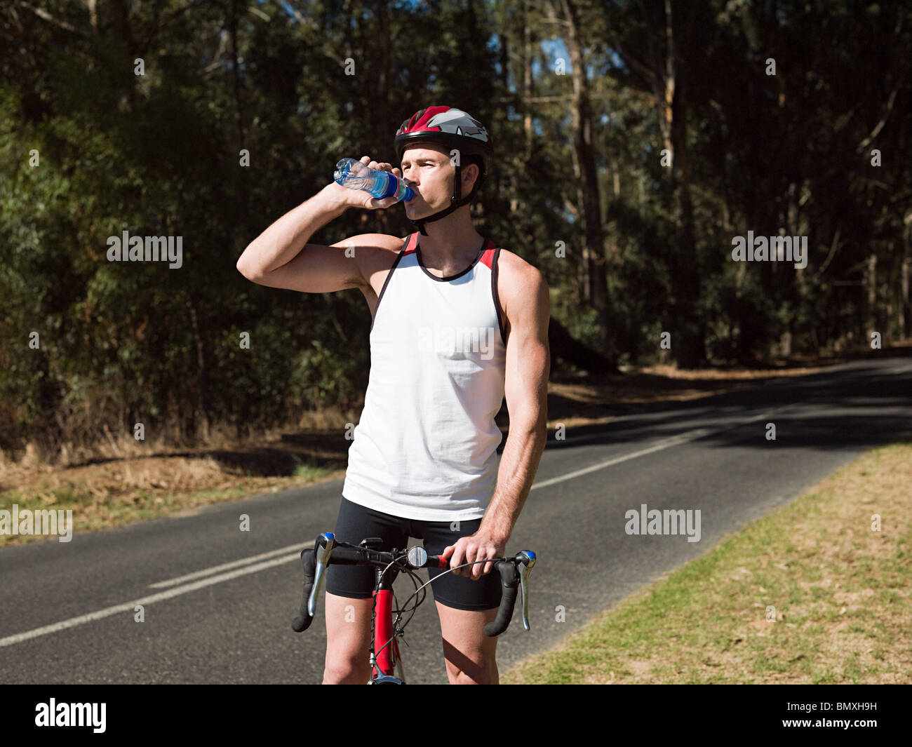Young man cycling on road Stock Photo - Alamy