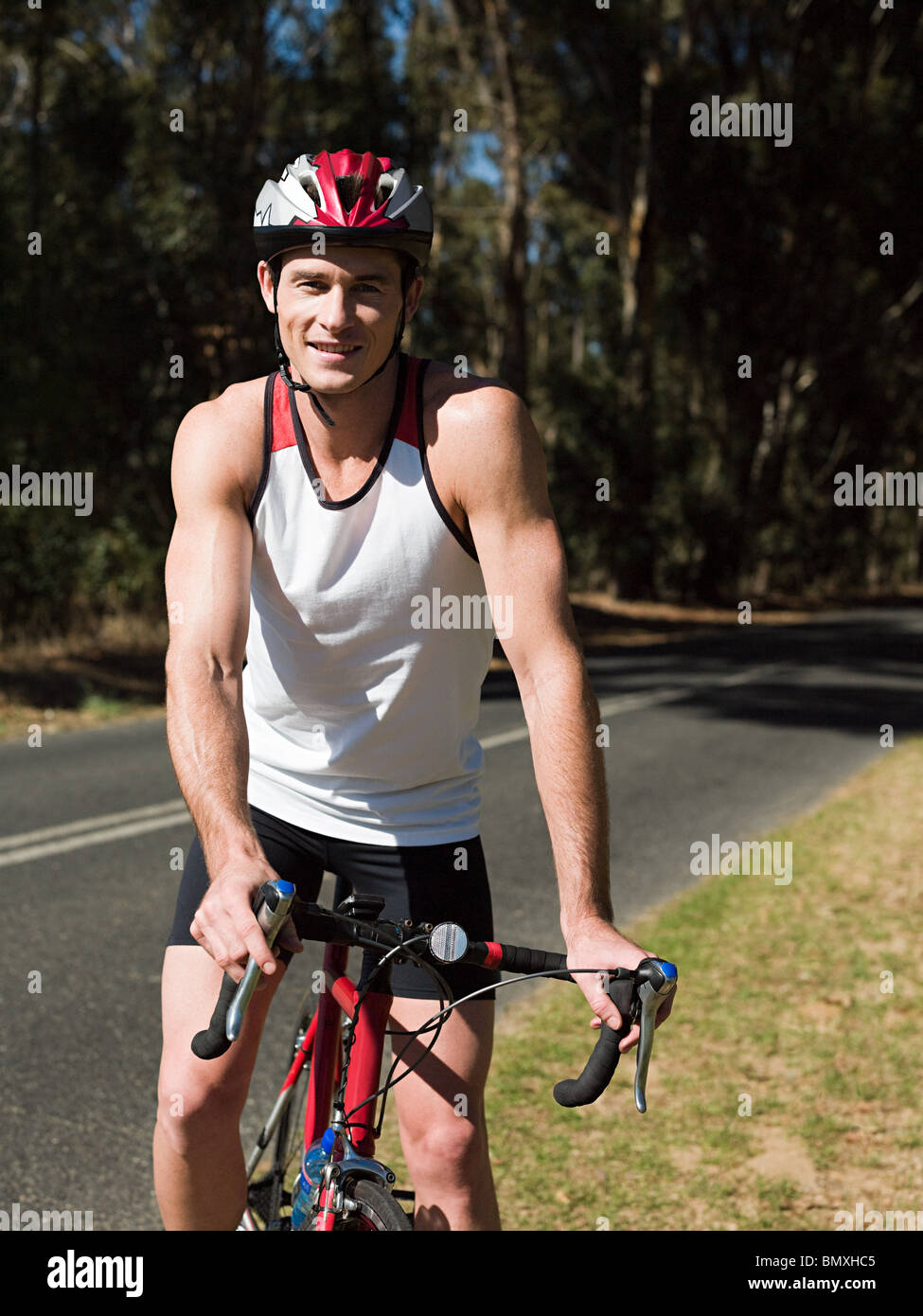 Young man cycling on road Stock Photo - Alamy