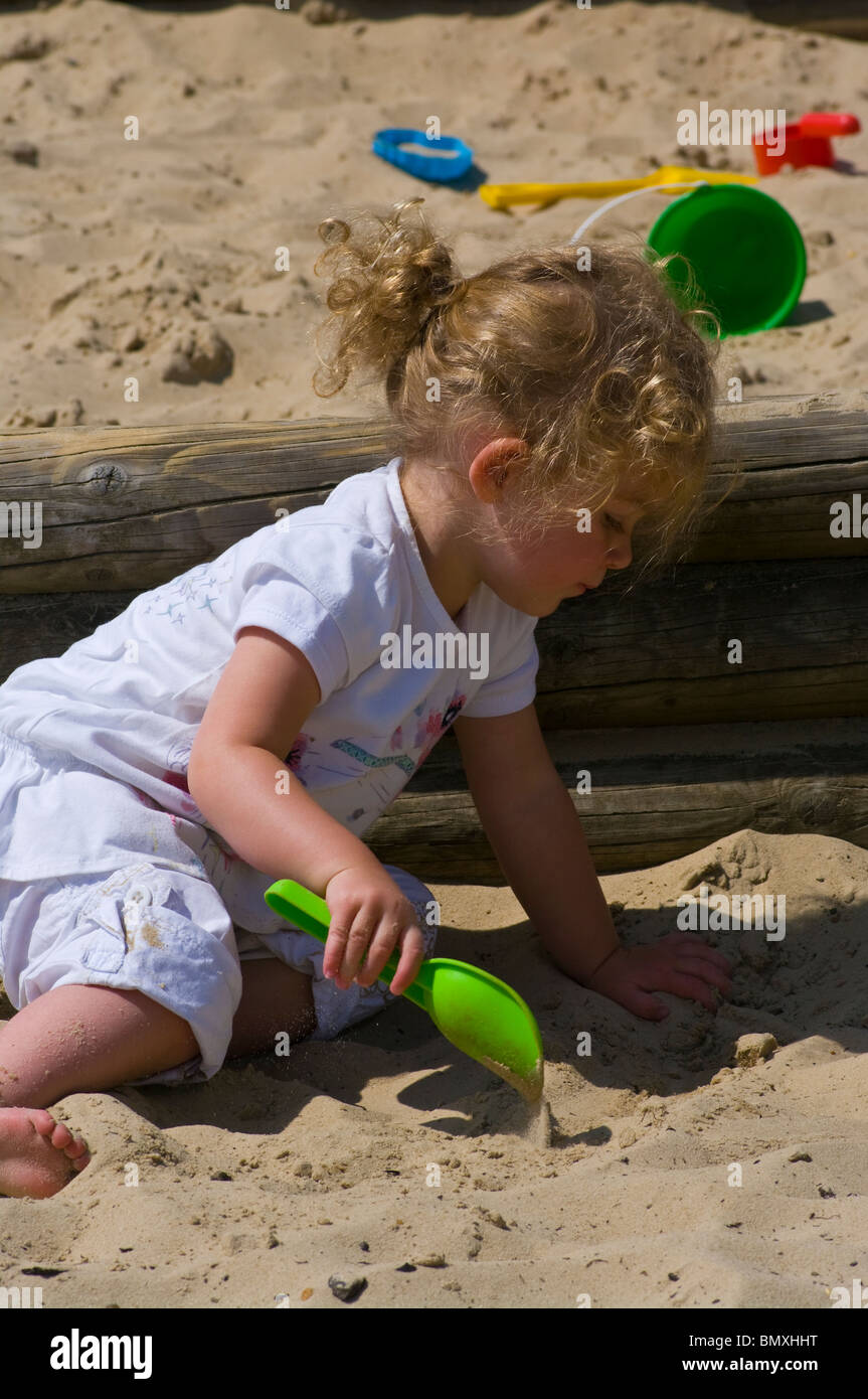 Girl playing in sand pit hi-res stock photography and images - Alamy