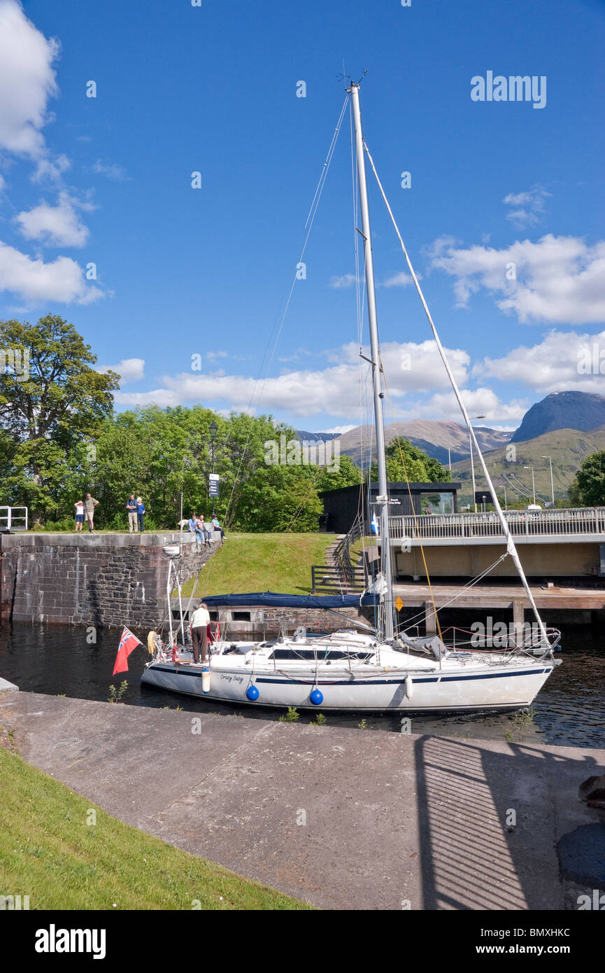 A yacht is passing through the Caledonian Canal at Banavie Fort William ...