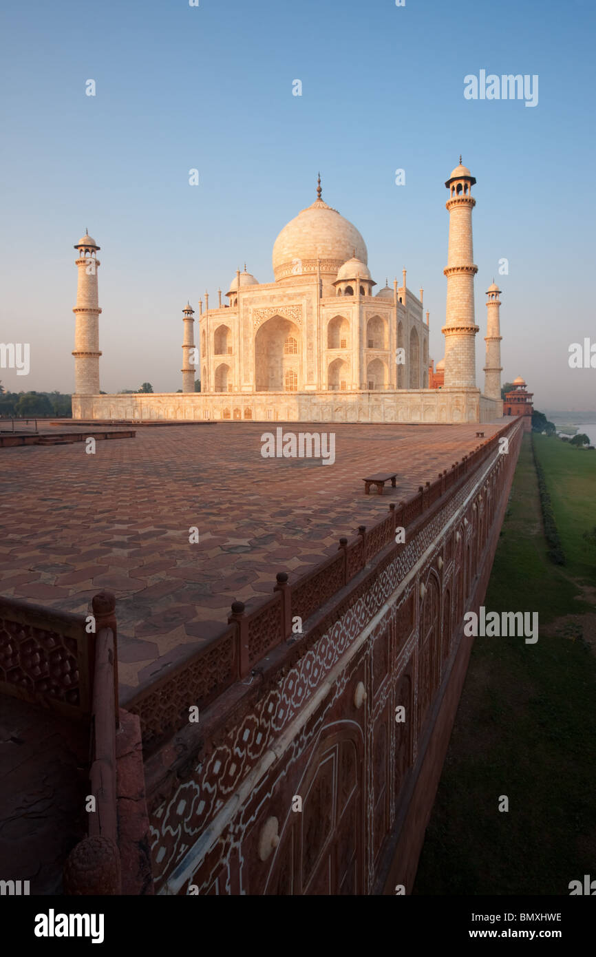 The red sandstone base of the Taj Mahal rises out of the bank of the ...