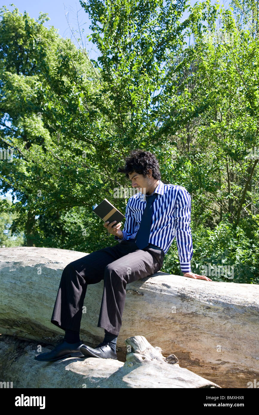 Young man in business dress, reading (Shakespeare) in the park Stock ...