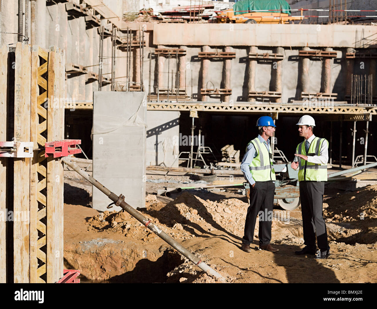 Mature men meeting on construction site Stock Photo - Alamy
