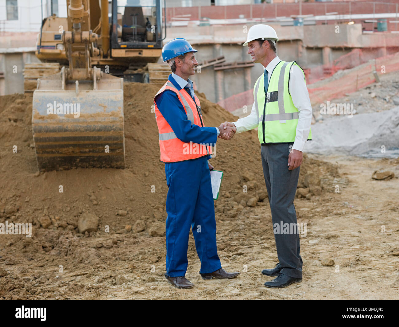 Mature men meeting on construction site Stock Photo - Alamy