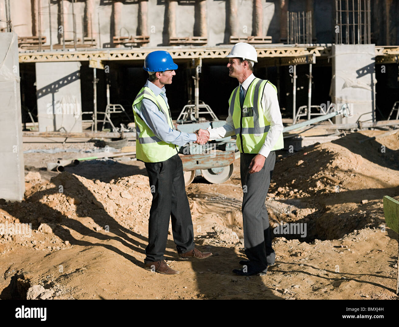 Mature men meeting on construction site Stock Photo - Alamy