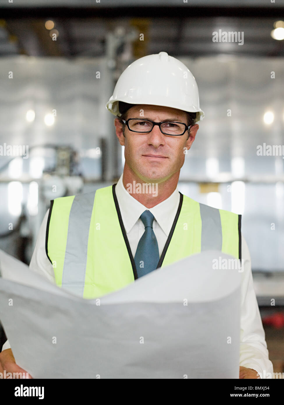 Mature man with blueprint in factory, portrait Stock Photo - Alamy