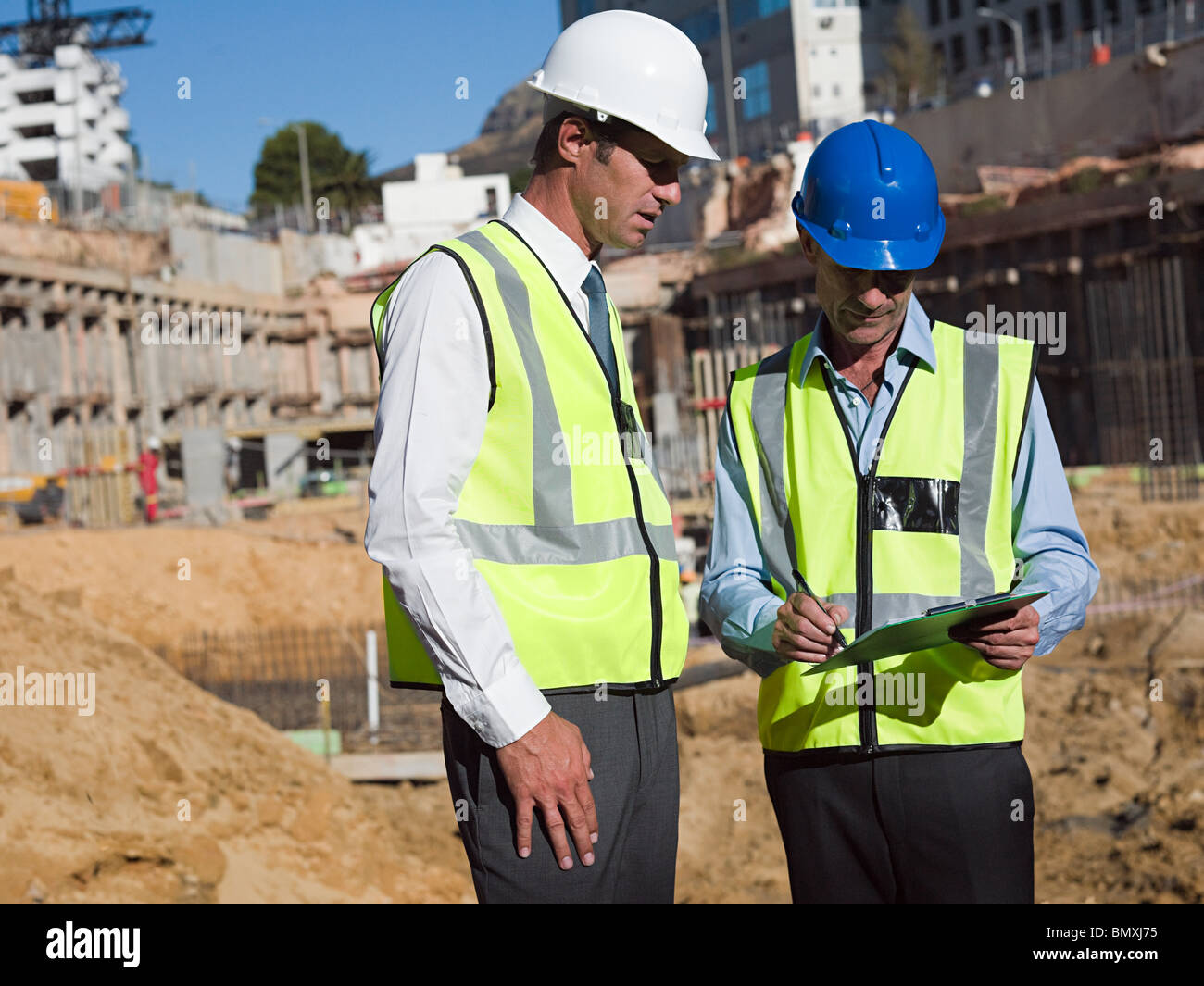 Mature men meeting on construction site Stock Photo - Alamy