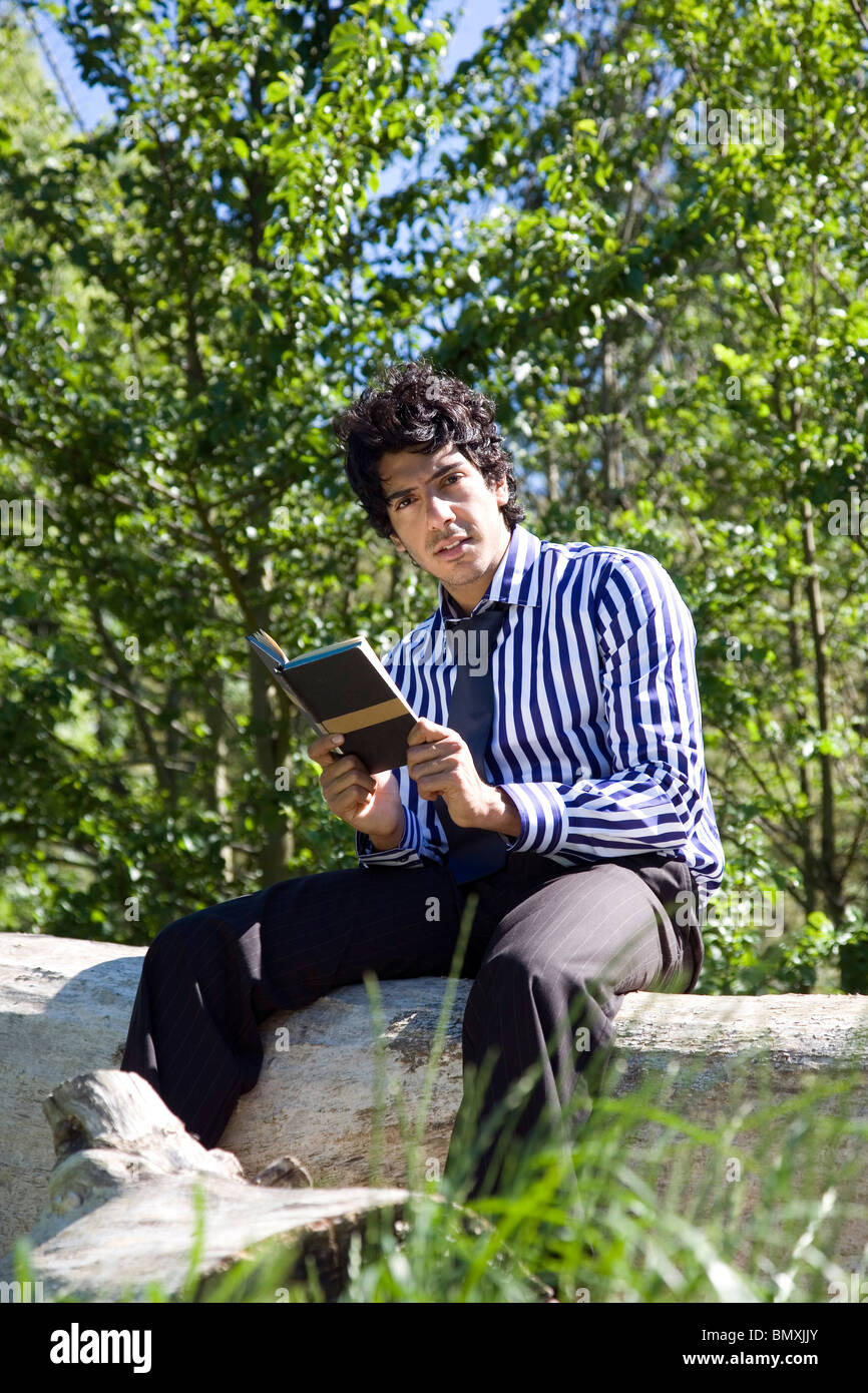 Young man in business dress, reading (Shakespeare) in the park Stock ...