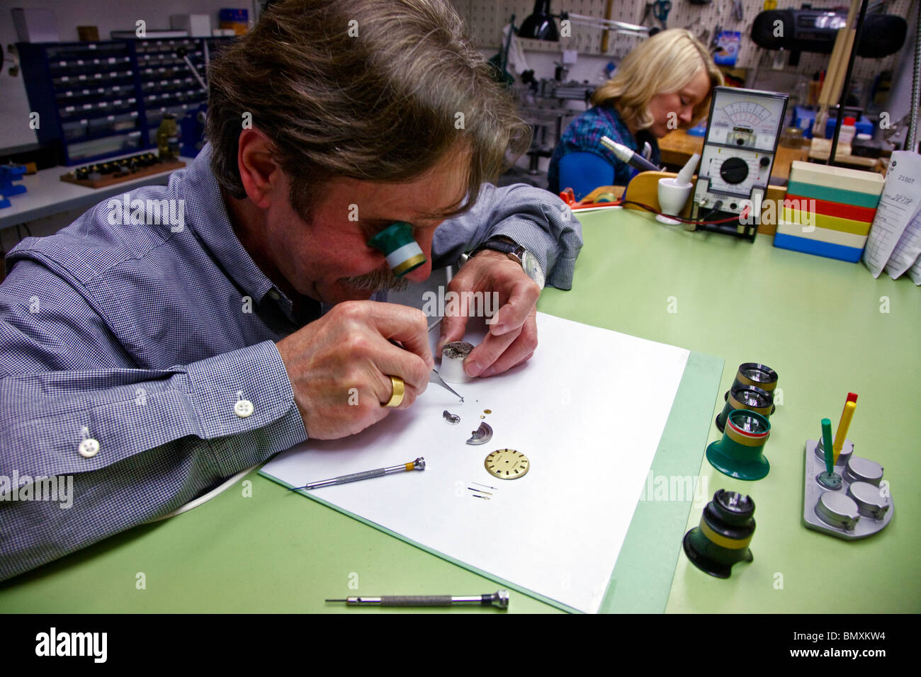 Master Watchmaker in his workshop in Germany repairing a wristwatch ...