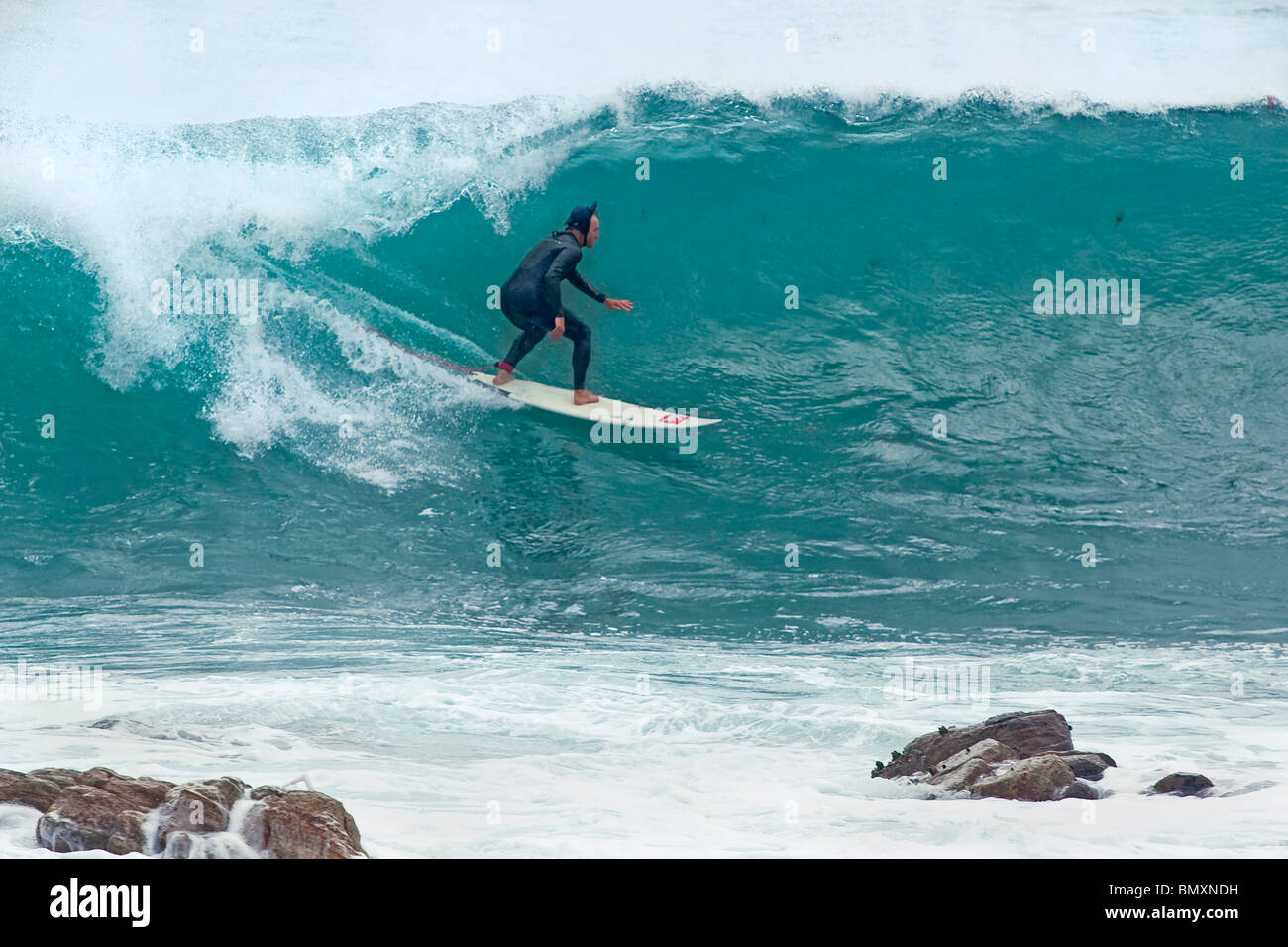 Surfer on a wave at Huzzawouie (Huzzas), a surf break at South Point ...