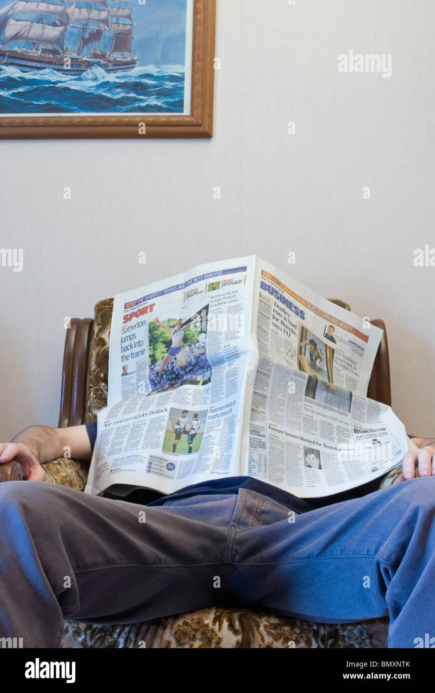 man sleeping in armchair with a newspaper over him Stock Photo - Alamy