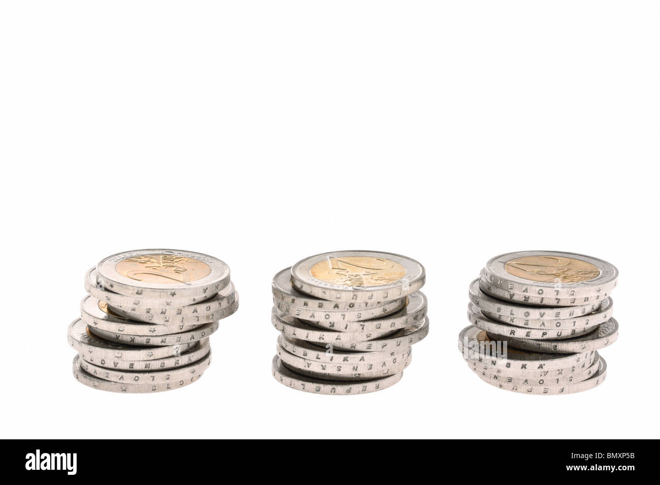 Three small columns of two-euro coins isolated on white background ...