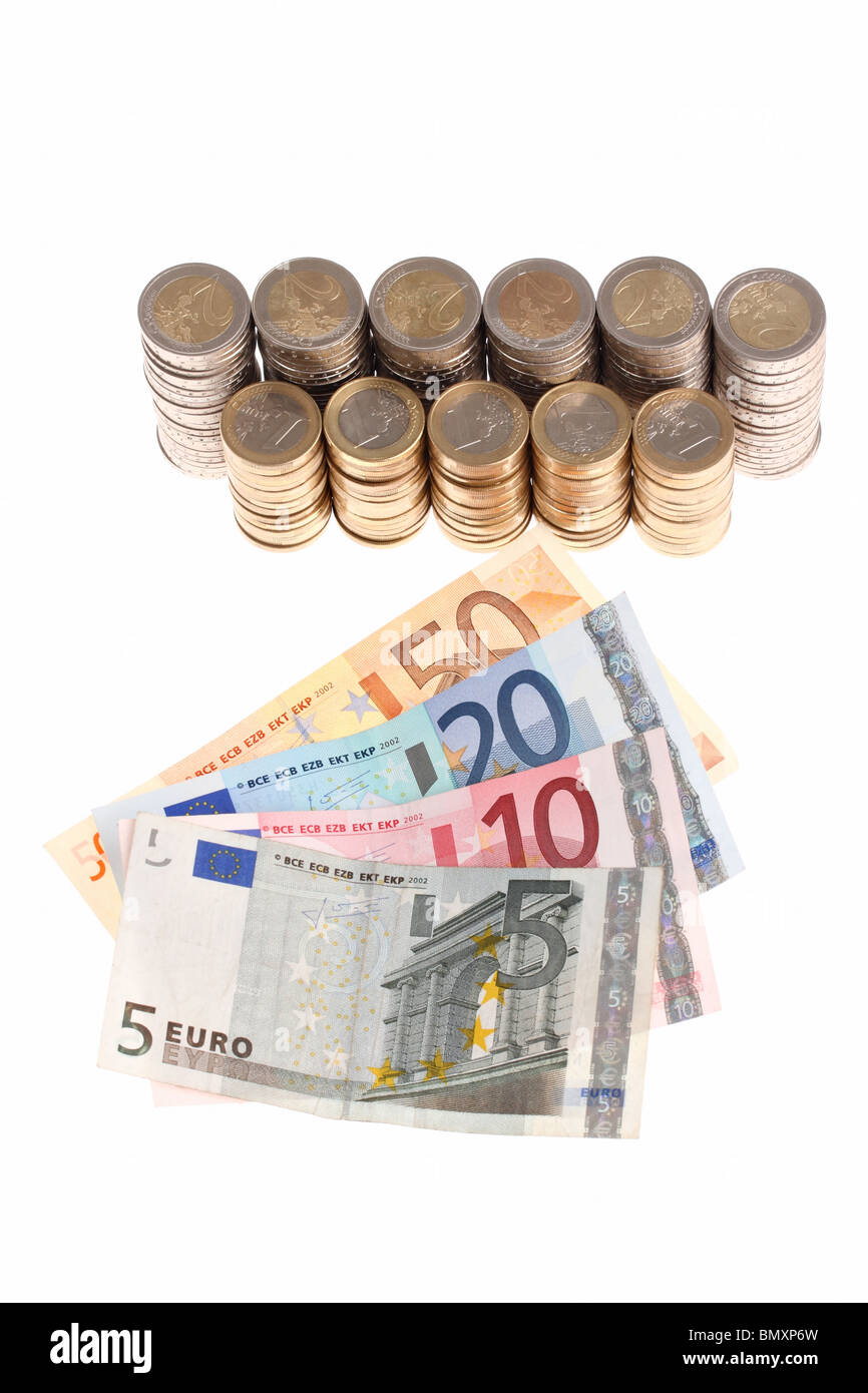 Euro banknotes and coins organized in columns isolated on white ...