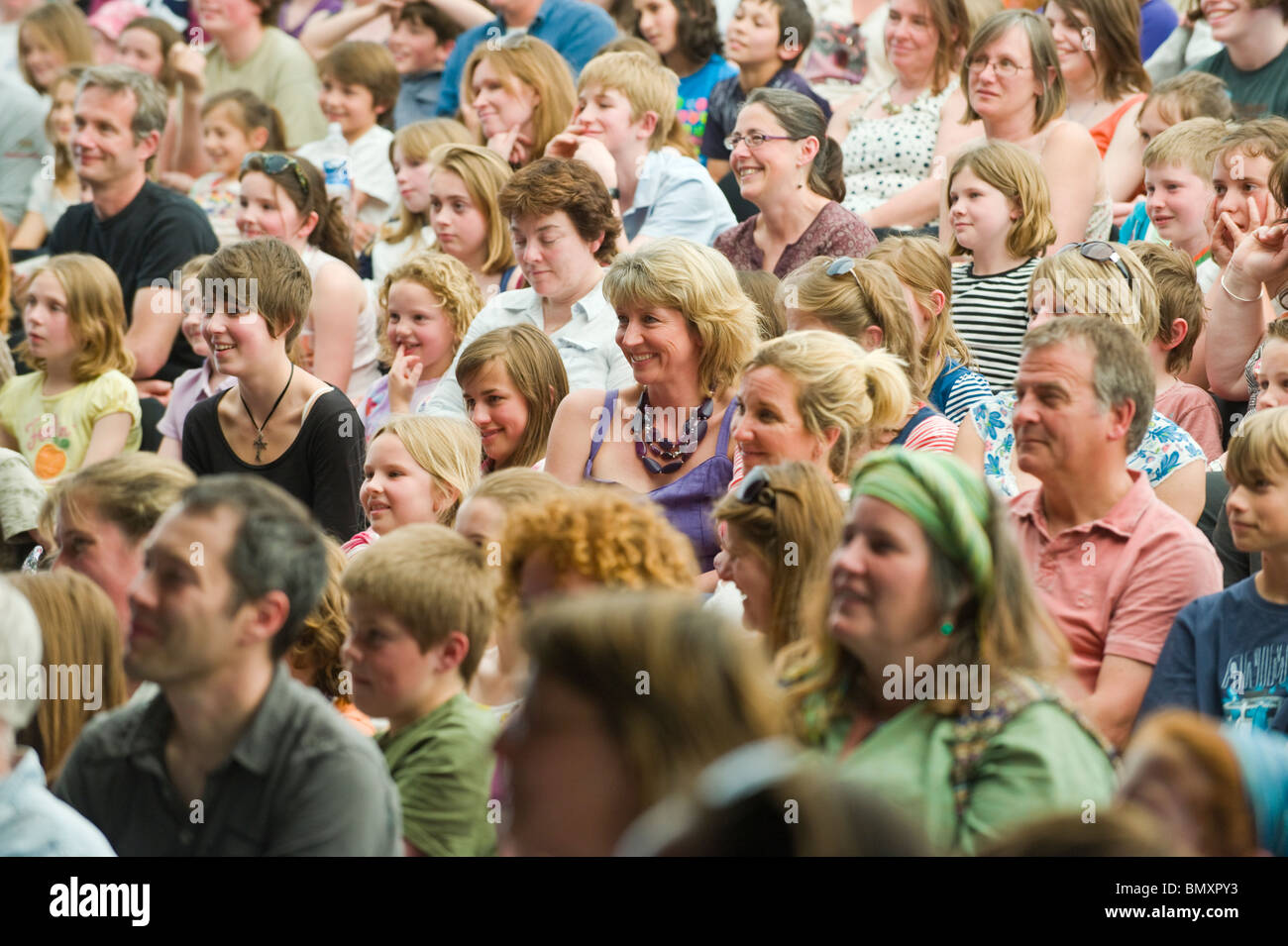 Family audience watching children's comedian James Campbell at Hay ...