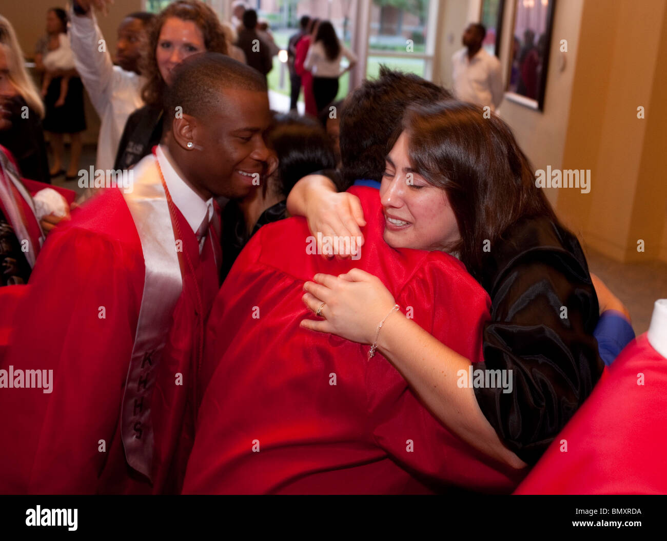 Hispanic boy hugs well-wisher after graduation ceremony from KIPP ...