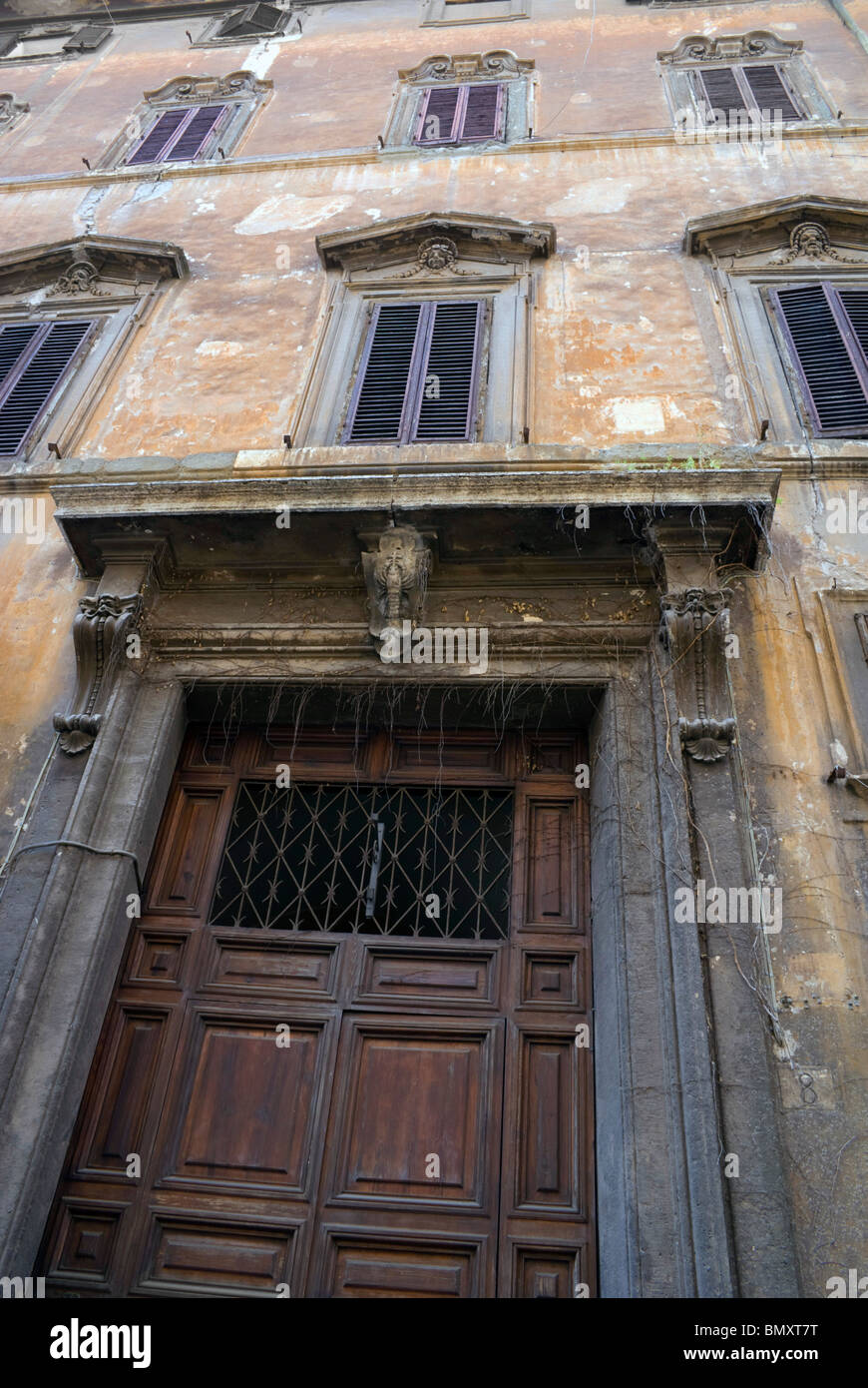The facade of a traditional, slightly shabby, building in Roman side ...