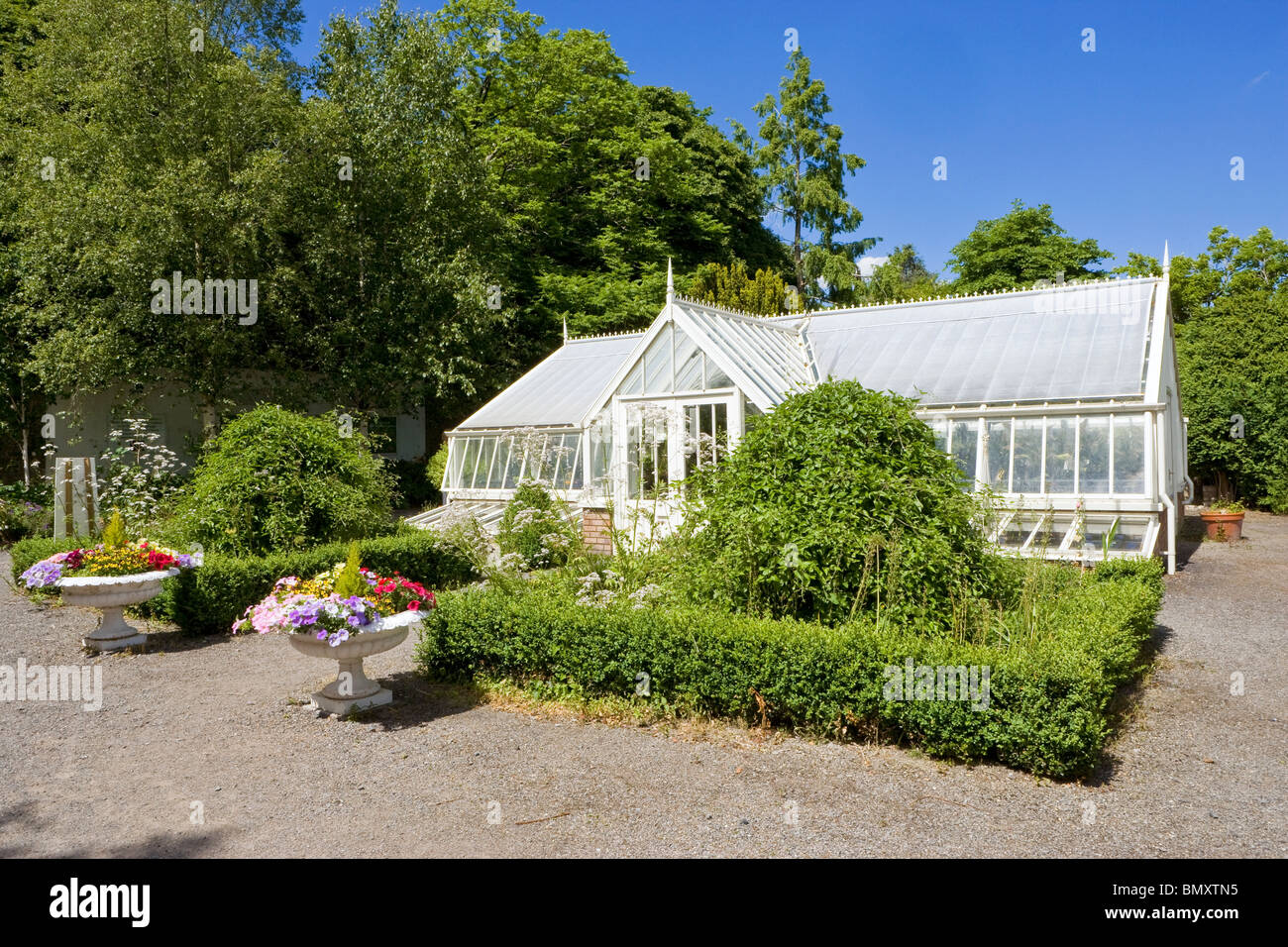 greenhouse in garden setting Stock Photo - Alamy