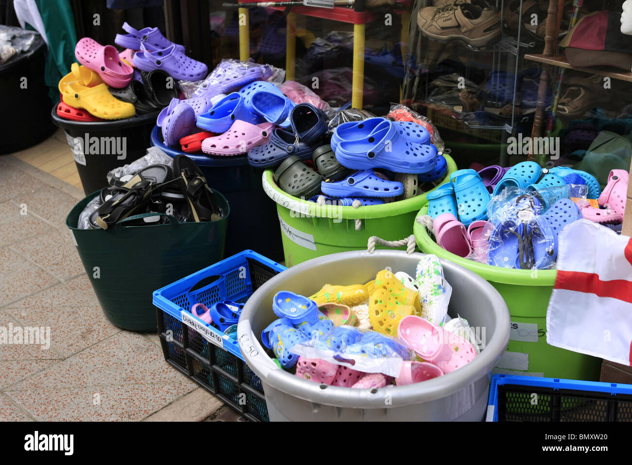 Rubber shoes for sale outside a shop Stock Photo - Alamy