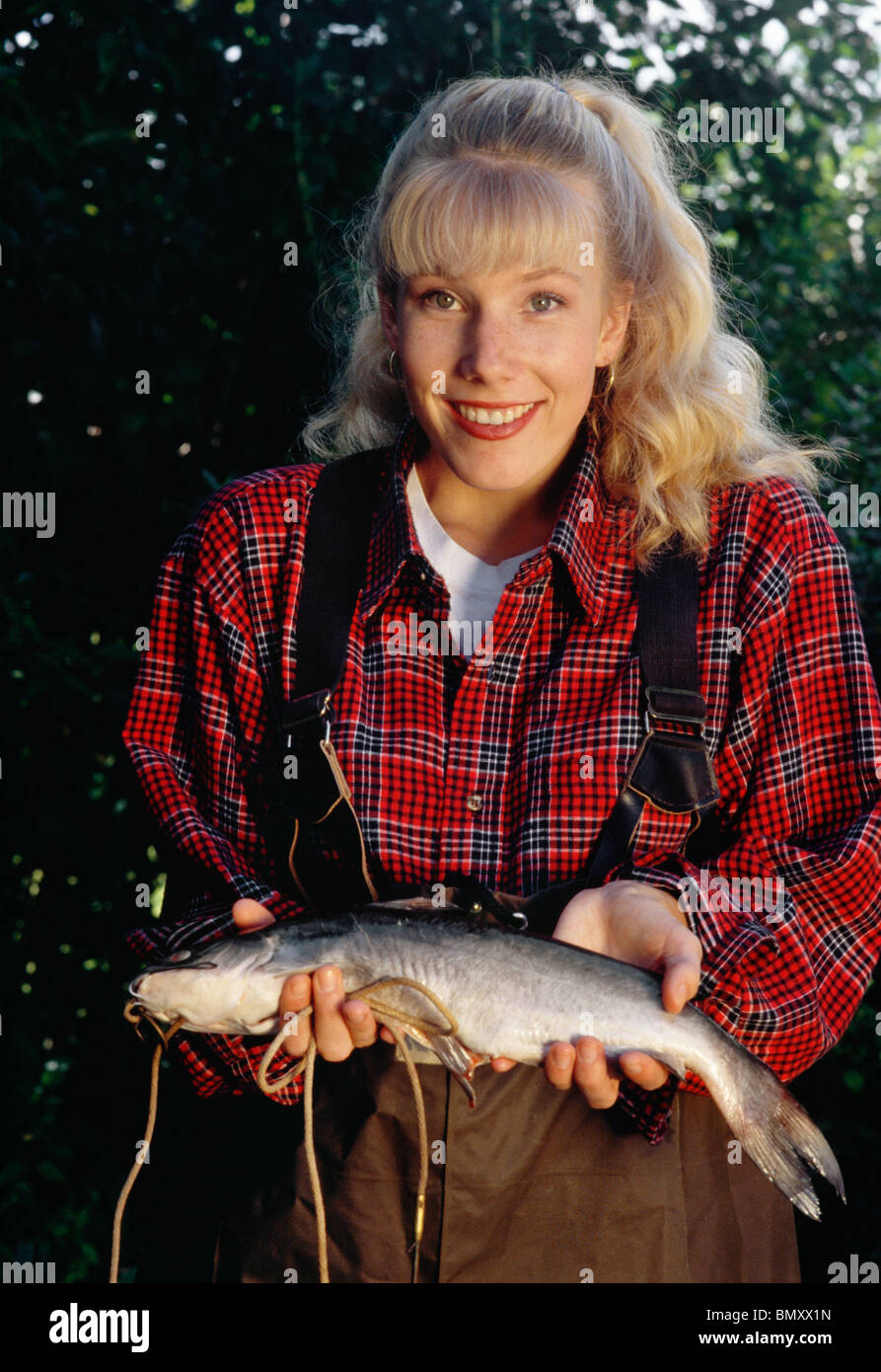 Young woman proudly displays her caught fish, USA Stock Photo - Alamy