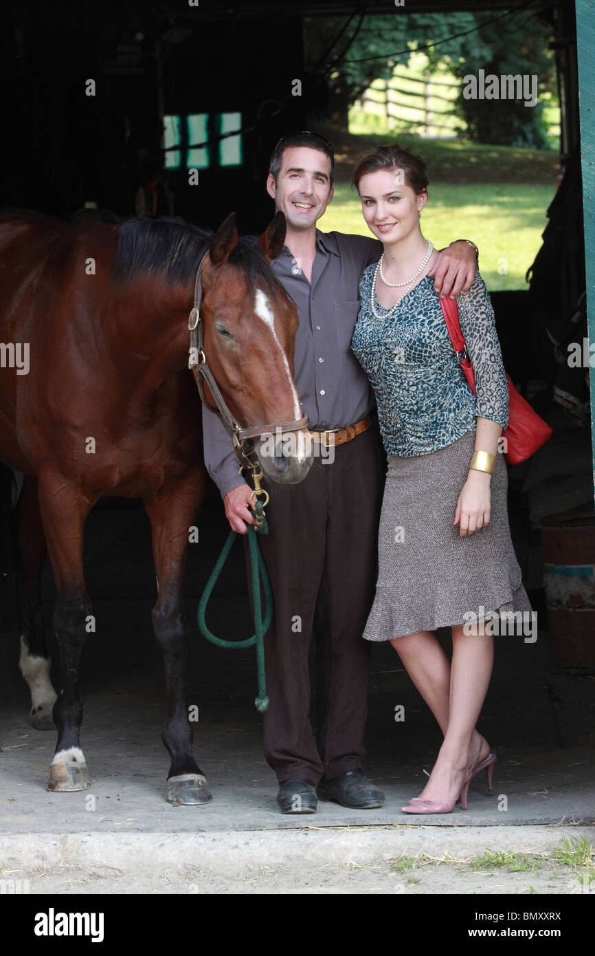 young couple with horse in barn Stock Photo - Alamy