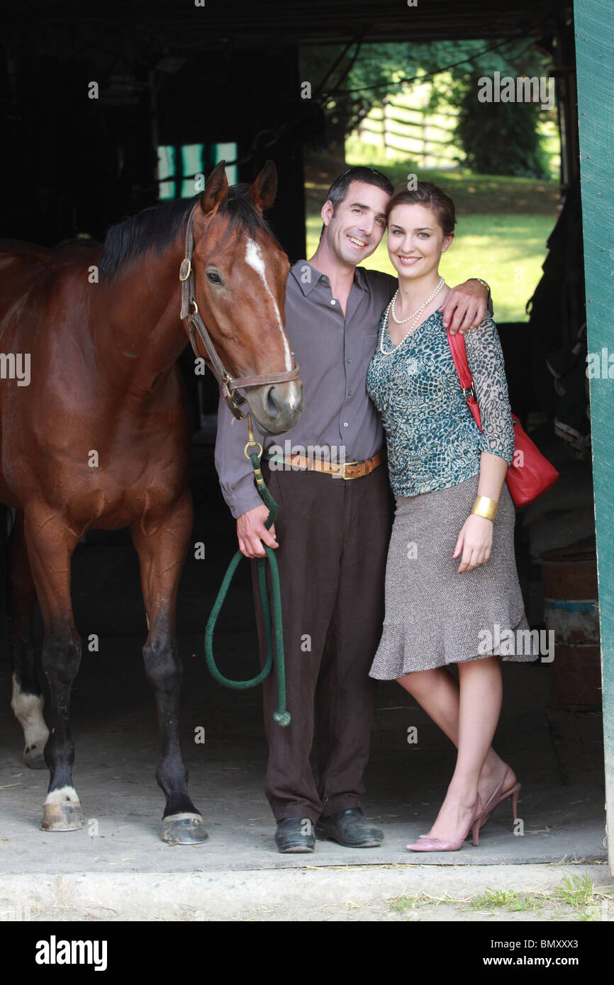 young couple with horse in barn Stock Photo - Alamy