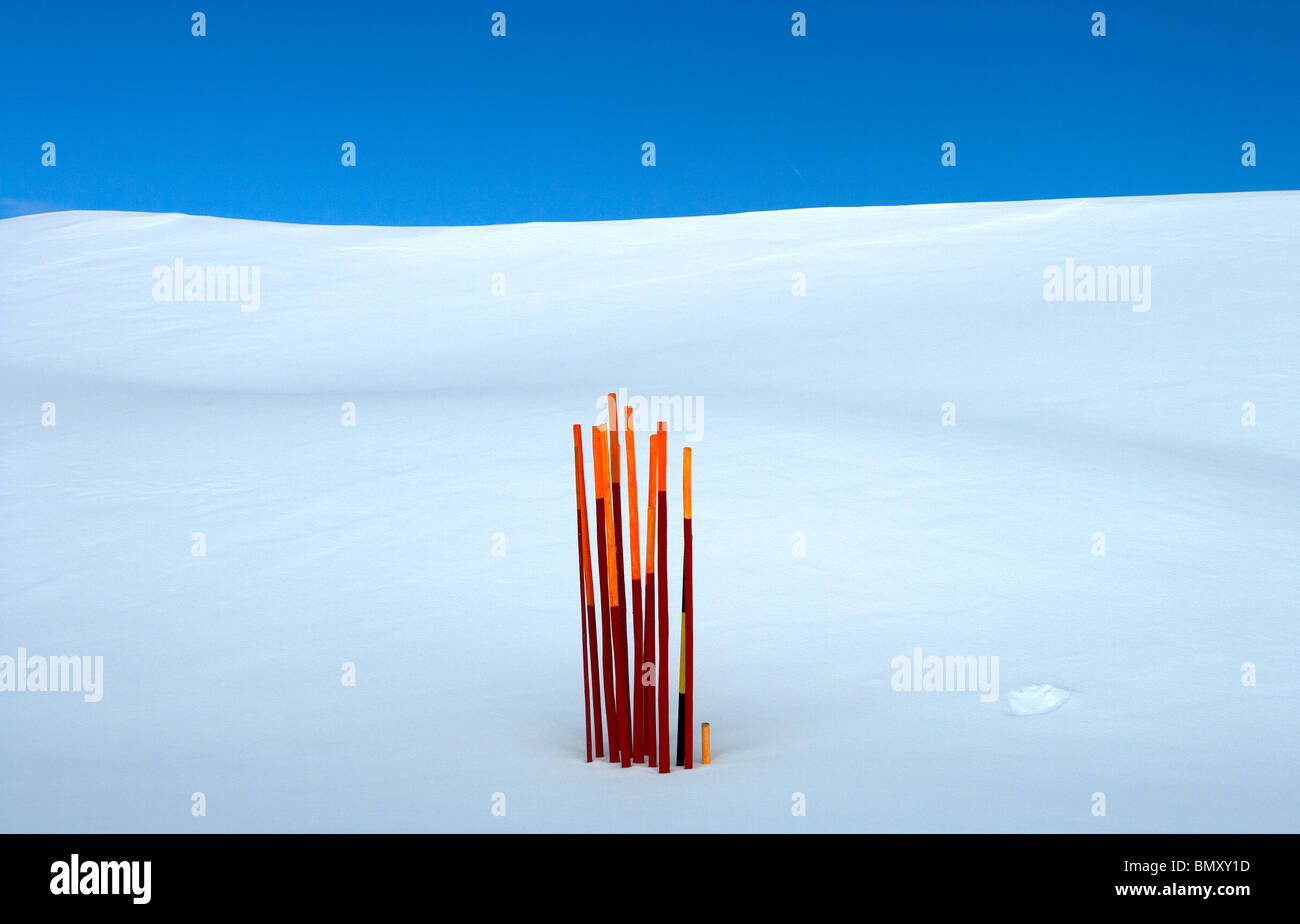 Coloured wooden marking posts in snow Stock Photo - Alamy
