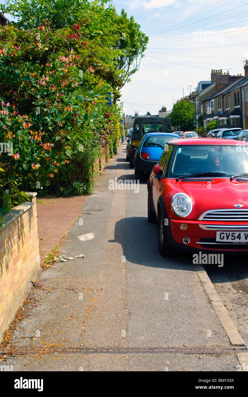 Cars parked on the footpath are an obstacle for pedestrians in Oxford ...