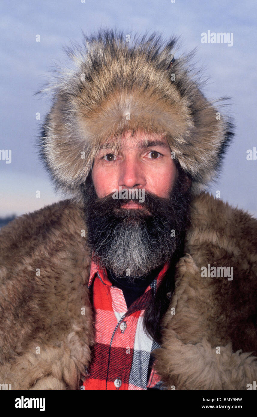 A bearded man wears a fur hat and parka in celebration of the annual ...