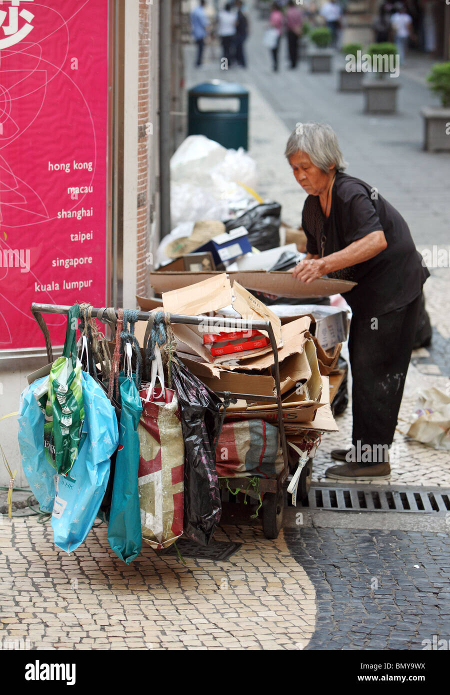 A woman stacking cardboard, Macao, China Stock Photo - Alamy
