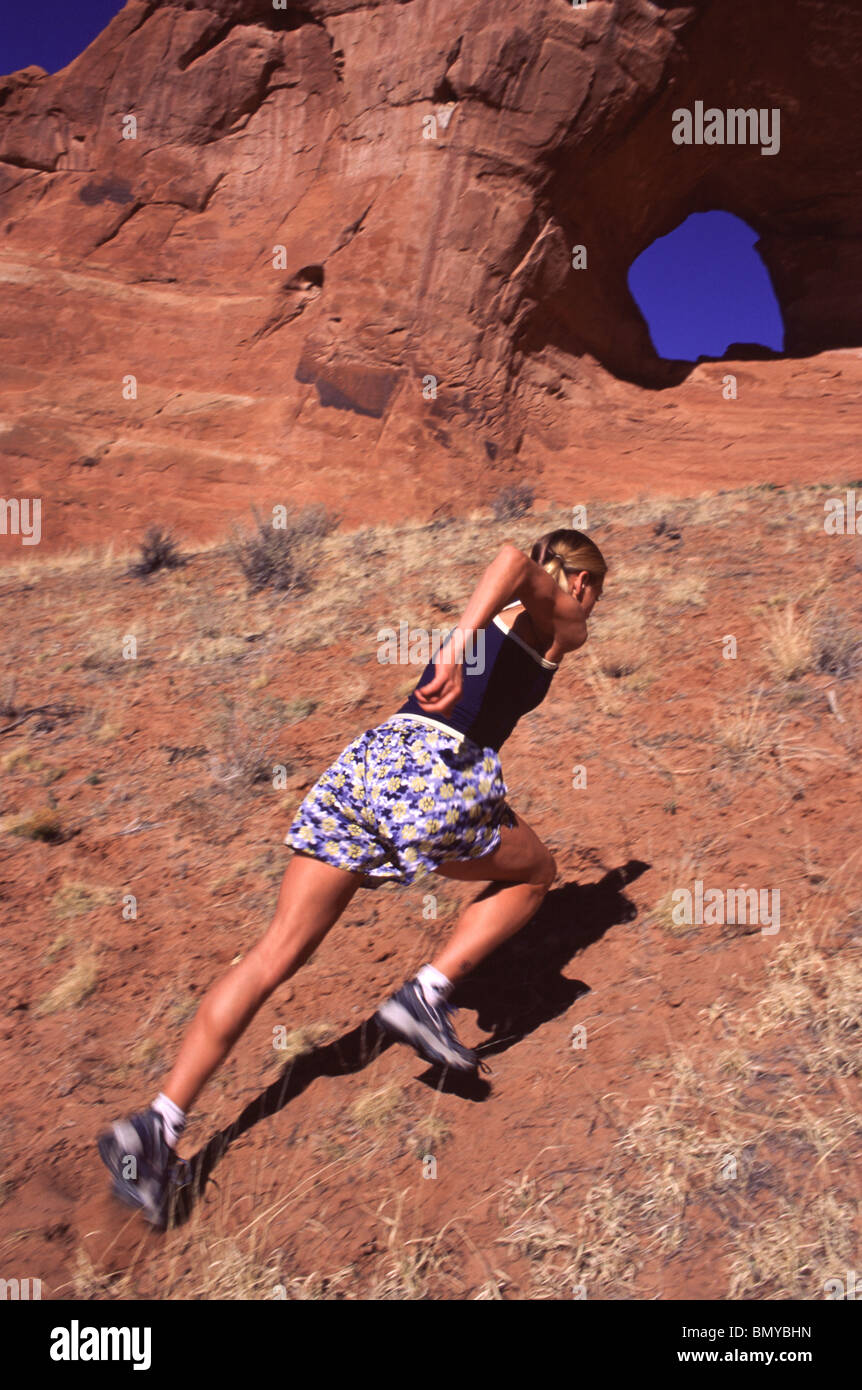 Woman running alone in the desert Stock Photo - Alamy