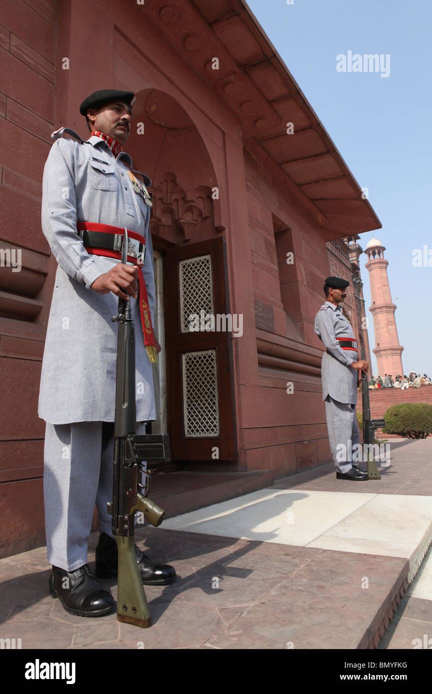 Guard at a mosque in lahore Stock Photo - Alamy