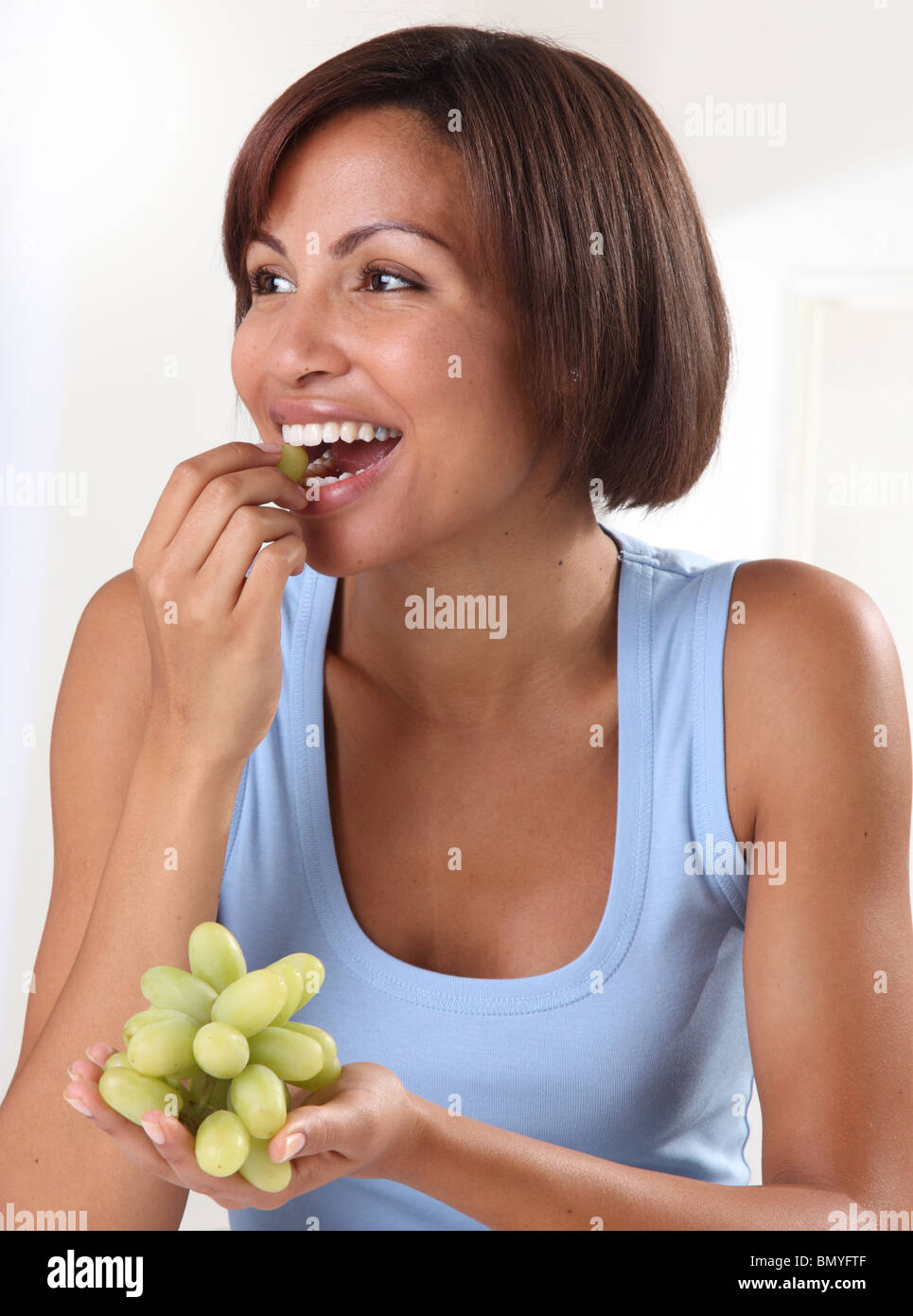 WOMAN EATING GRAPES Stock Photo - Alamy