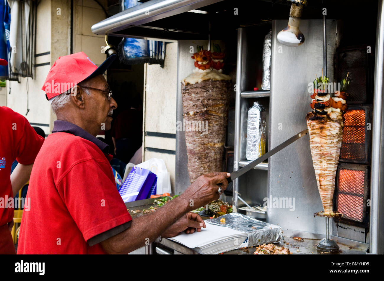 Cutting down the Shawarma in a popular Egyptian fast food restaurant ...