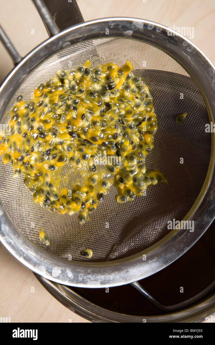 Passion Fruit pulp in sieve Stock Photo - Alamy