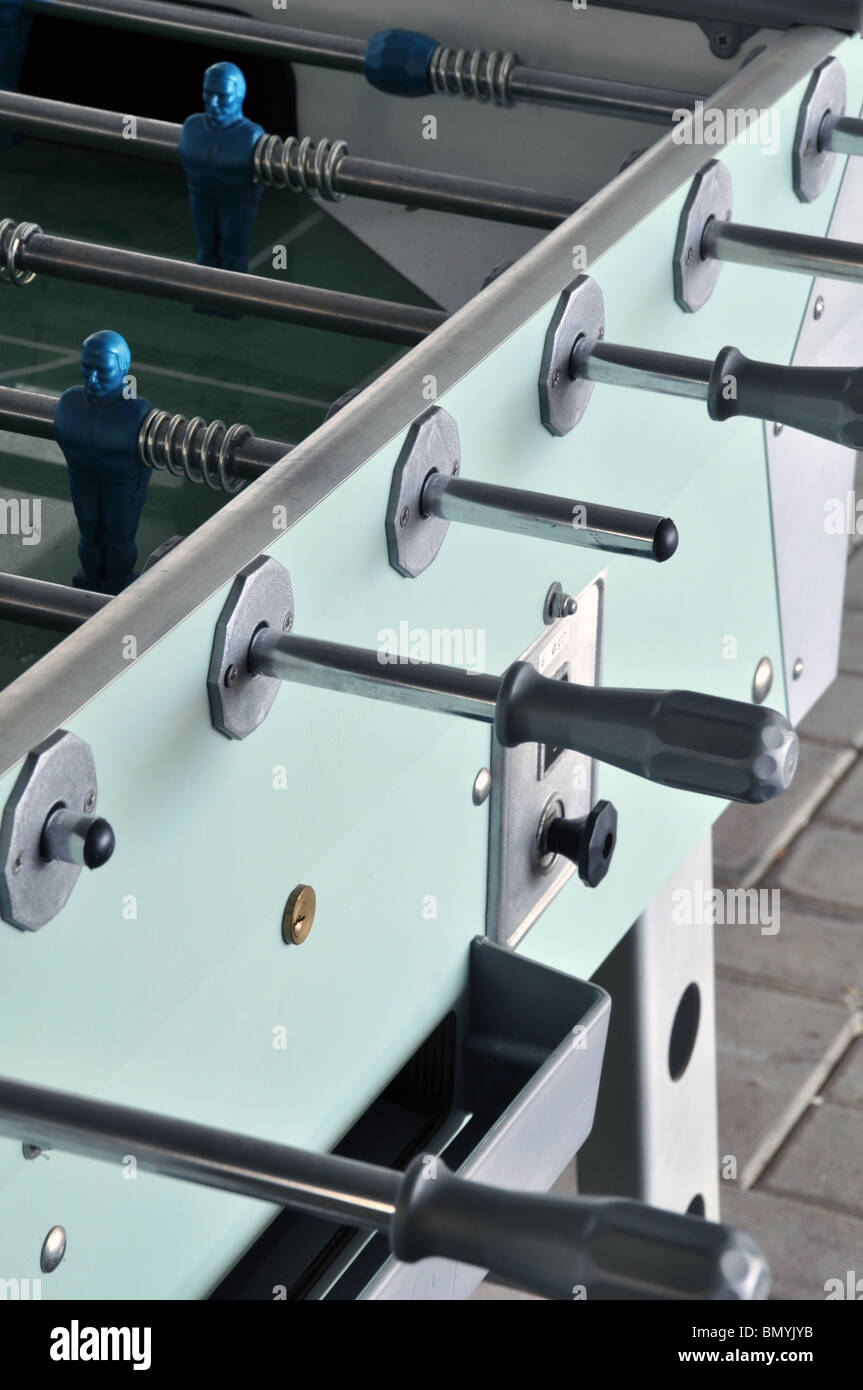 Closeup on foosball table with handles, coin slot and players Stock ...