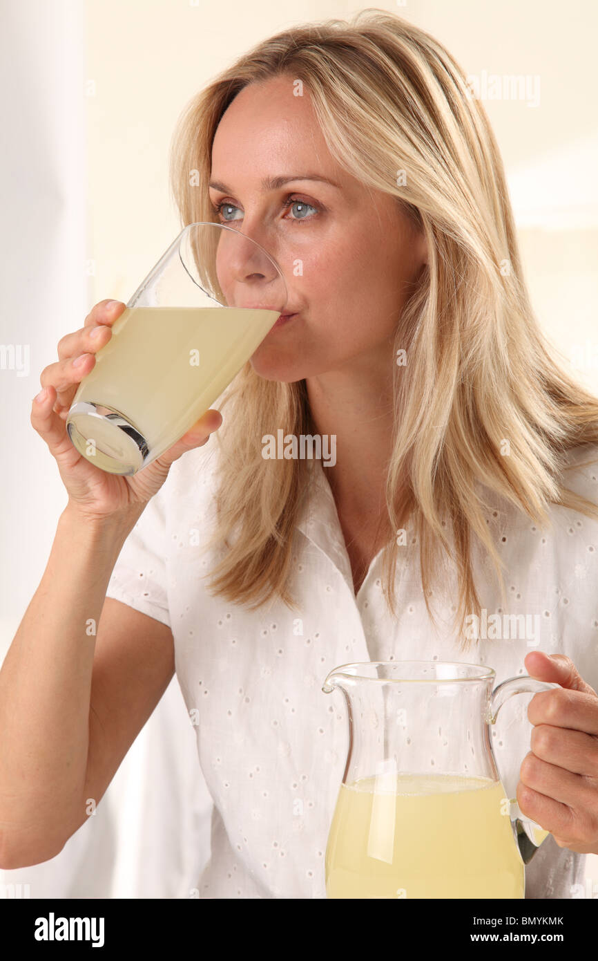WOMAN DRINKING LEMONADE Stock Photo - Alamy