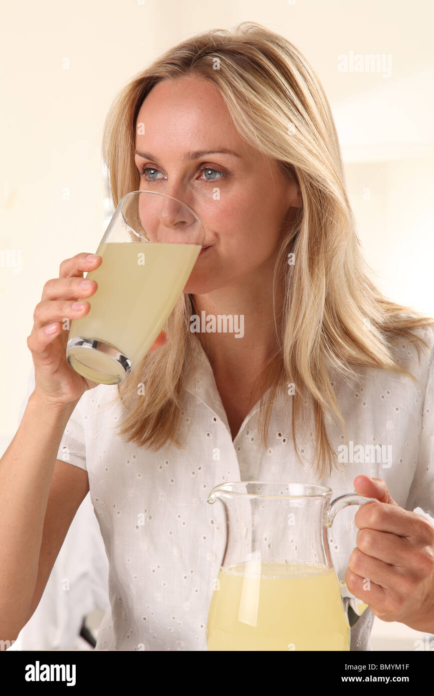 WOMAN DRINKING LEMONADE Stock Photo - Alamy