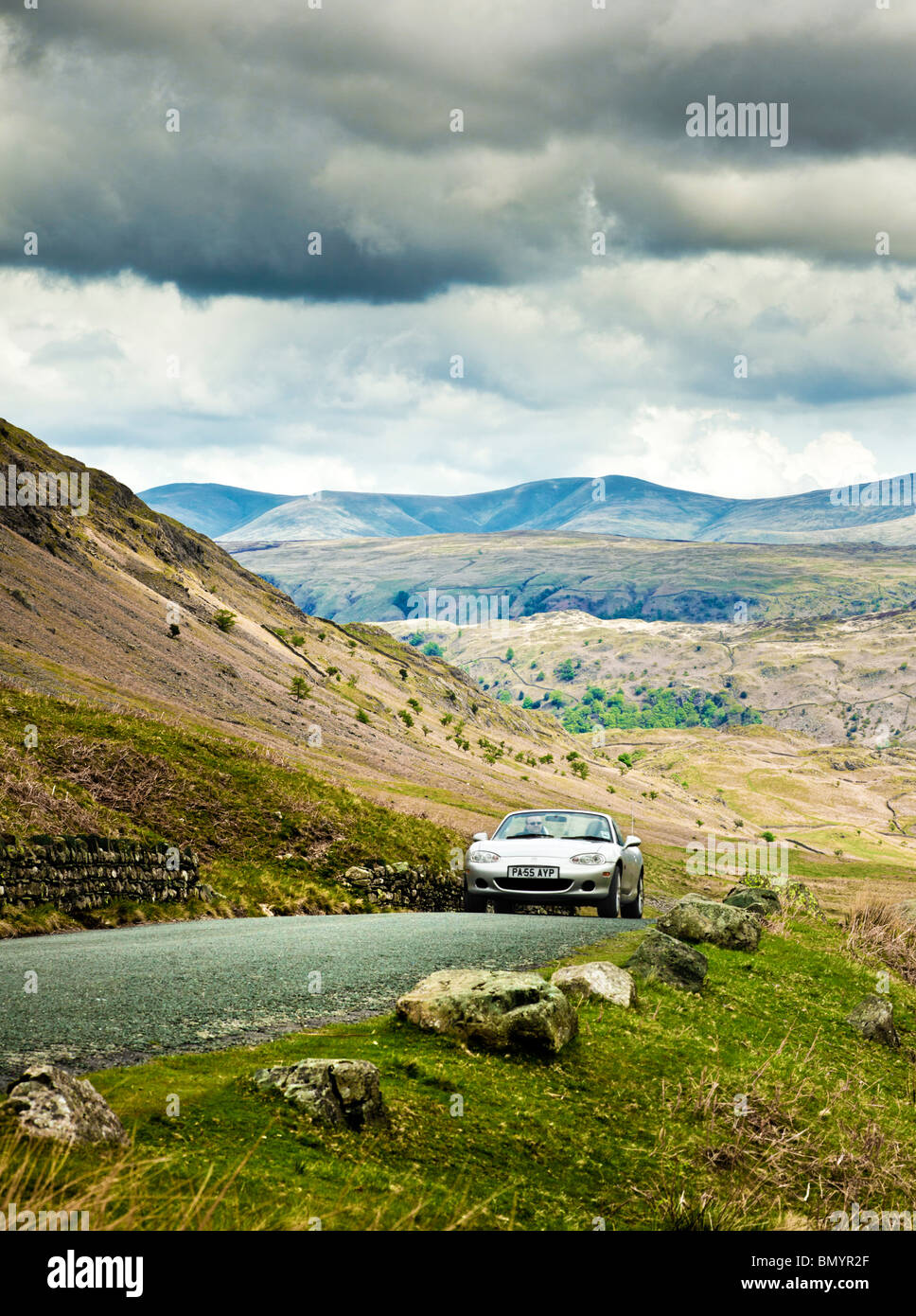 Driving, UK, Sports car driving on a mountain road in The Lake District ...