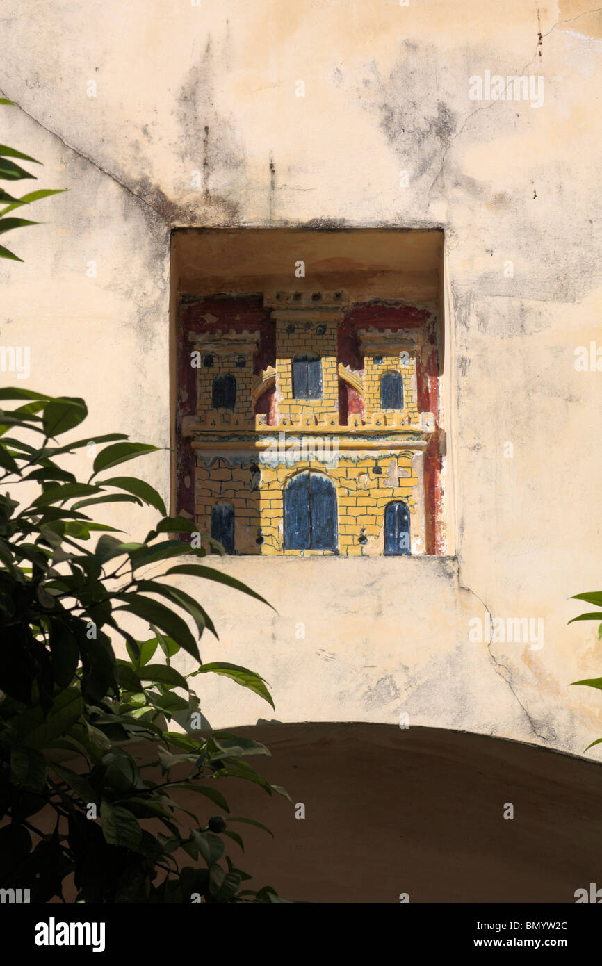 A picture tile set into a wall alcove in the Reales Alcazares gardens ...
