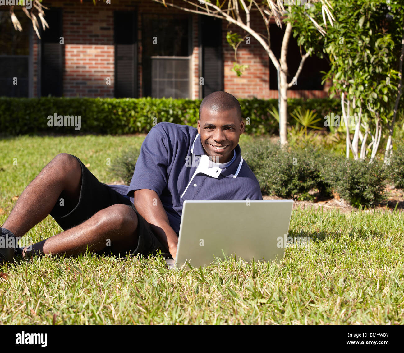 Black man typing on laptop Stock Photo - Alamy