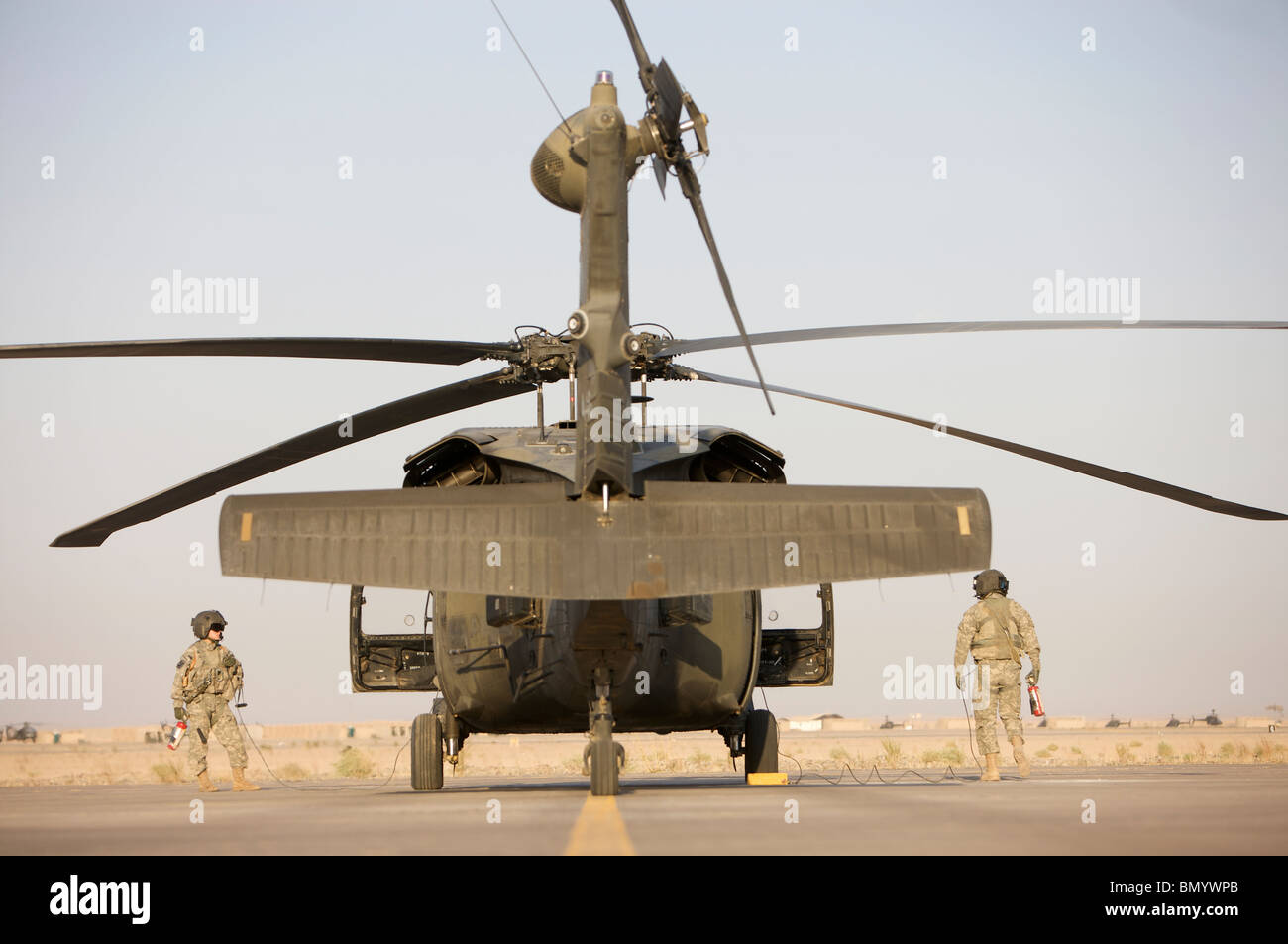 Crew Chiefs stand beside their UH-60L Black Hawk helicopter Stock Photo ...
